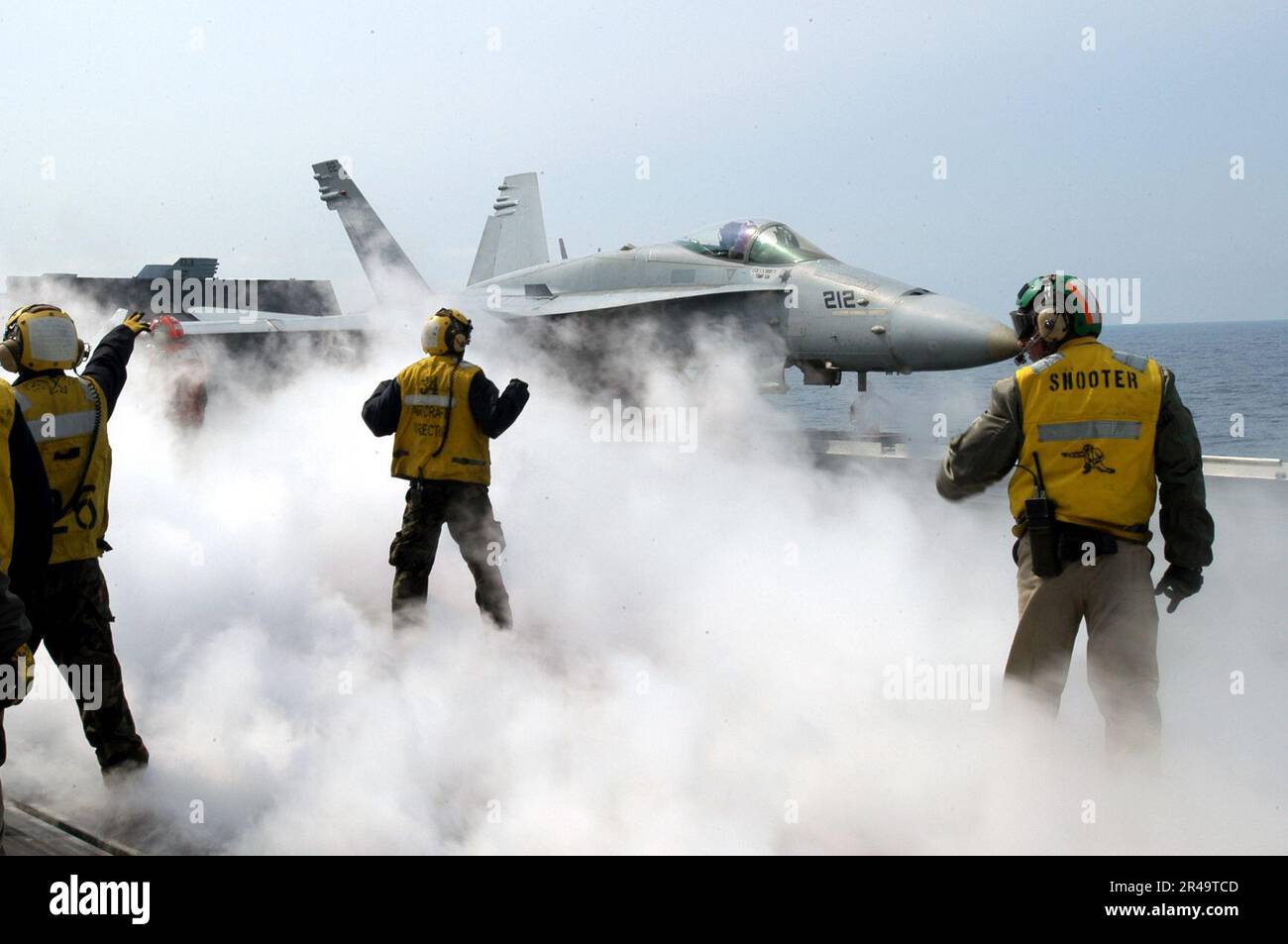US Navy An Aviation Boatswain's Mate directs an aircraft onto one of ...