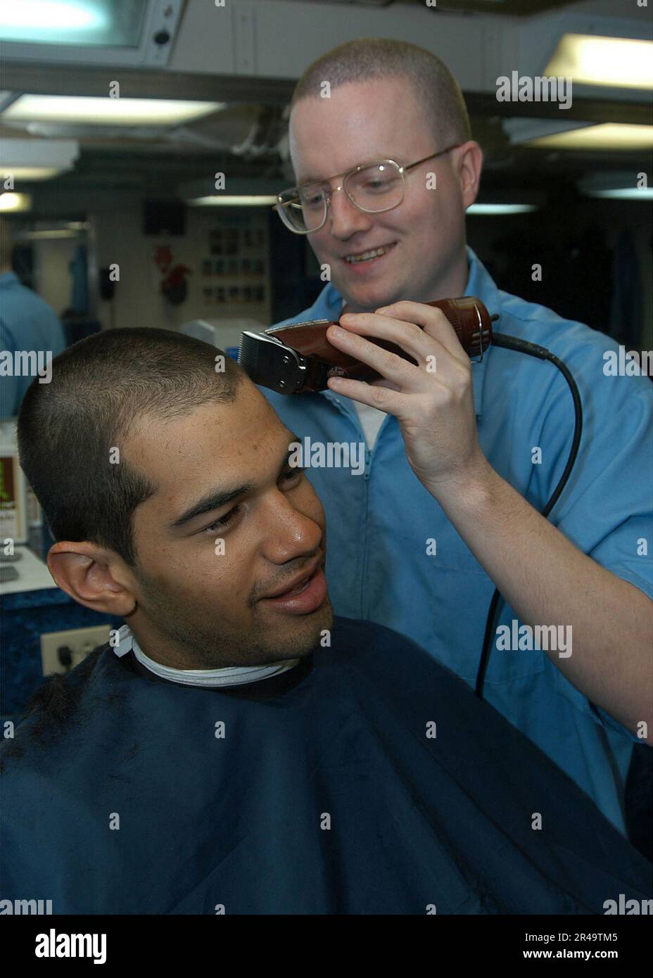 US Navy Ship's Serviceman Seaman gives Aviation Boatswain's Mate Airman ...