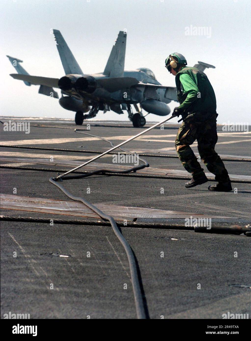 US Navy An Aviation Boatswain's Mate keeps the arresting cable on track ...