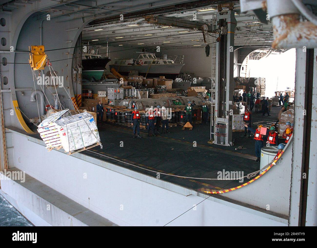 US Navy Cargo stores are hi-lined from the Military Sealift Command (MSC) combat stores ship ...