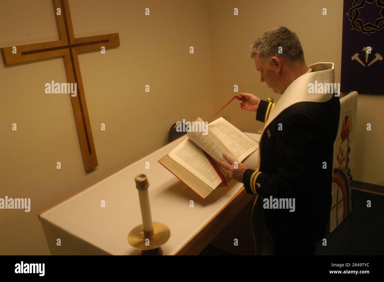 US Navy Navy Chaplain leafs through the Holy Bible aboard the Naval ...