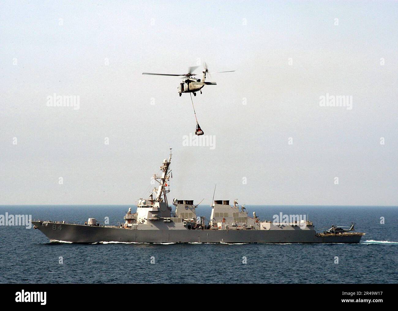 US Navy An MH-60S Knighthawk delivers cargo to the guided missile ...