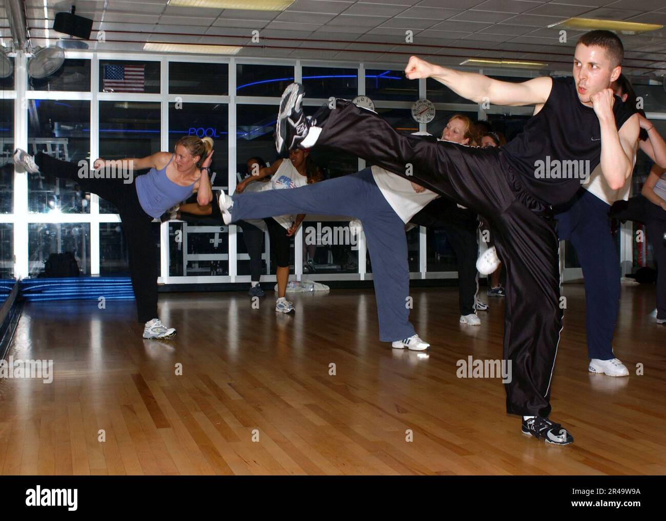US Navy Lt. and other students enjoy a kickboxing workout from ...