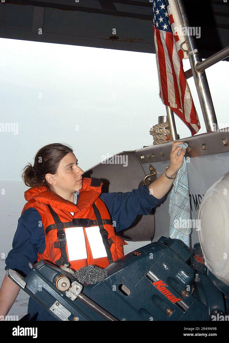 US Navy Seaman Apprentice polishes the metal railing on a Rigid Hull ...