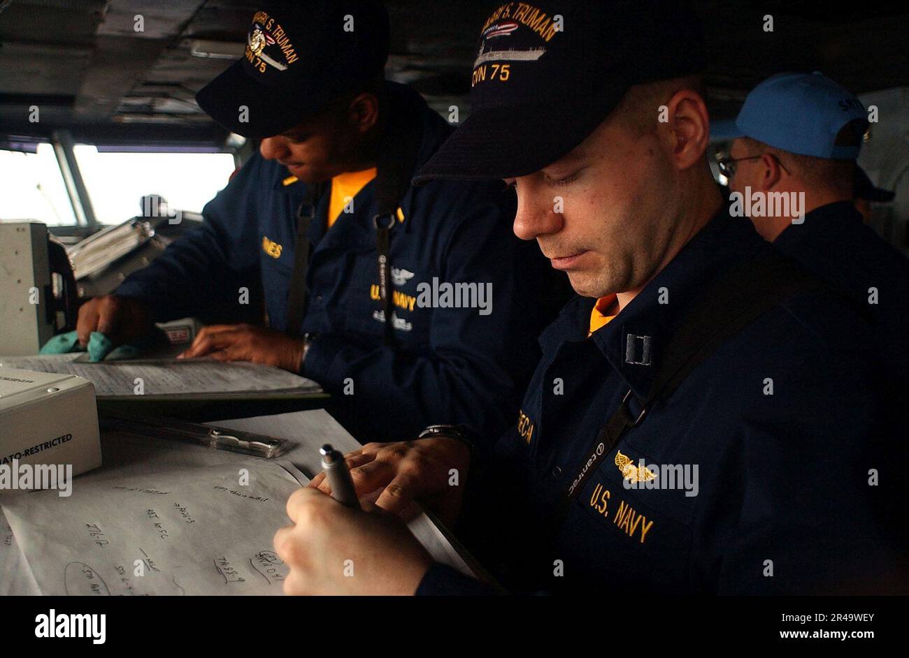 US Navy Radar Junior Officer of the Watch (JOOW) makes log entries on ...