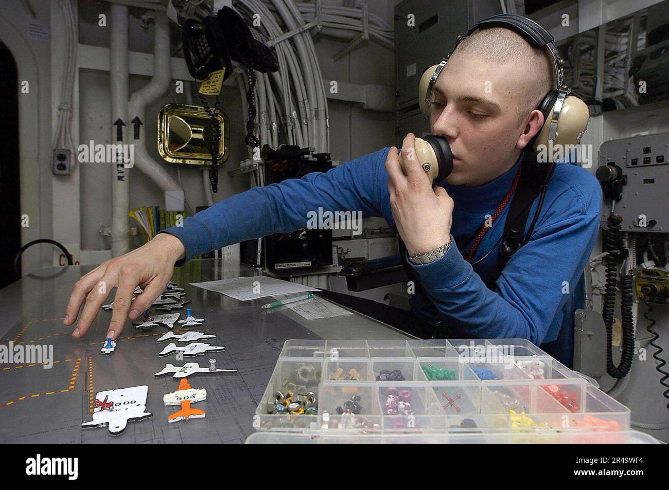 US Navy Airman checks the spotting of all aircraft in the hangar bay ...