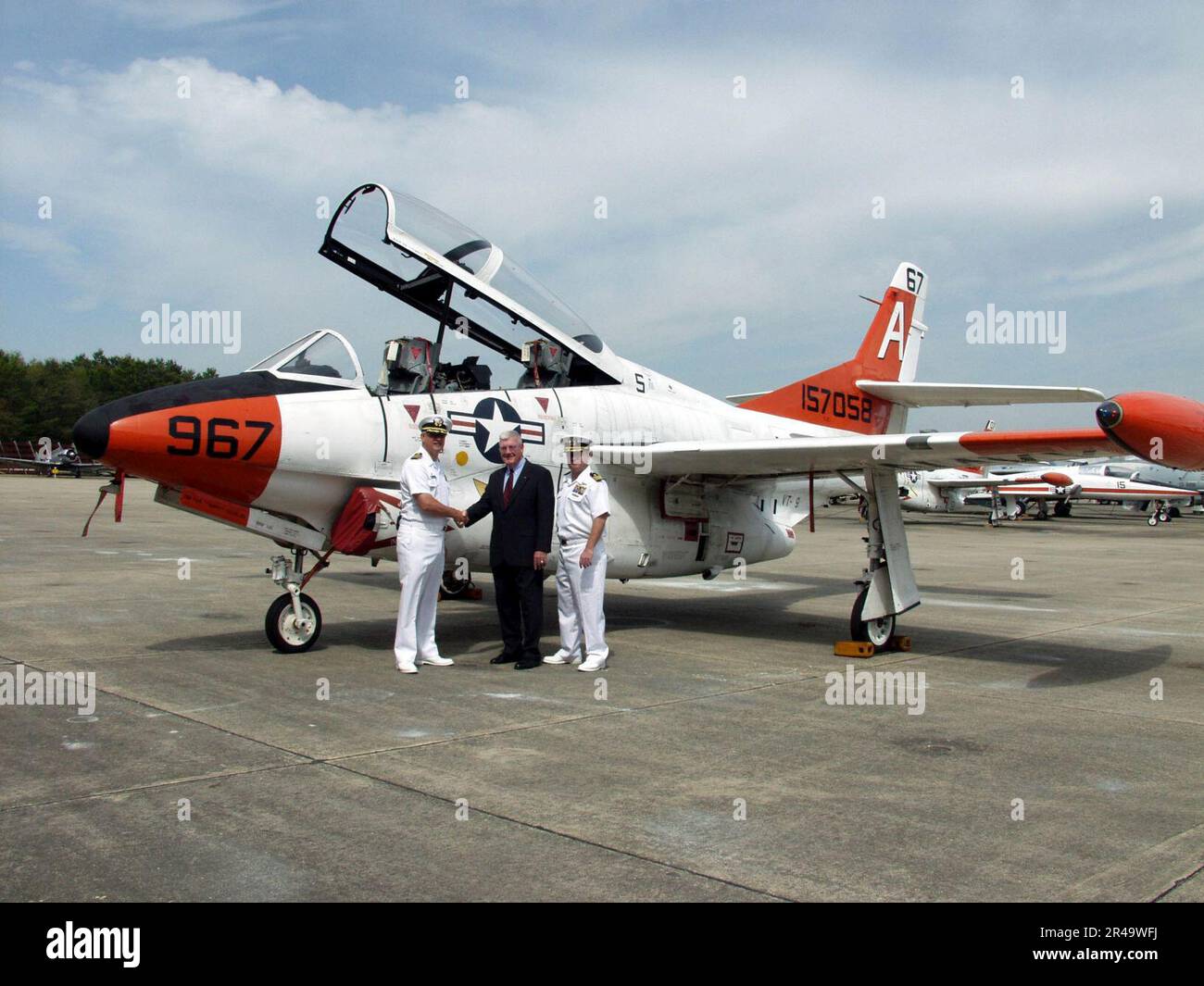 US Navy Commodore, Training Air Wing One (TW-1), left, presents the ...