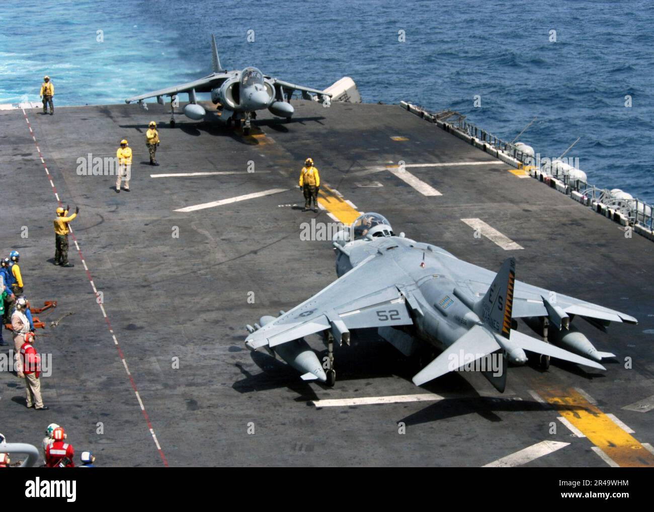 US Navy AV-8B Harriers taxi on the flight deck of the amphibious ...