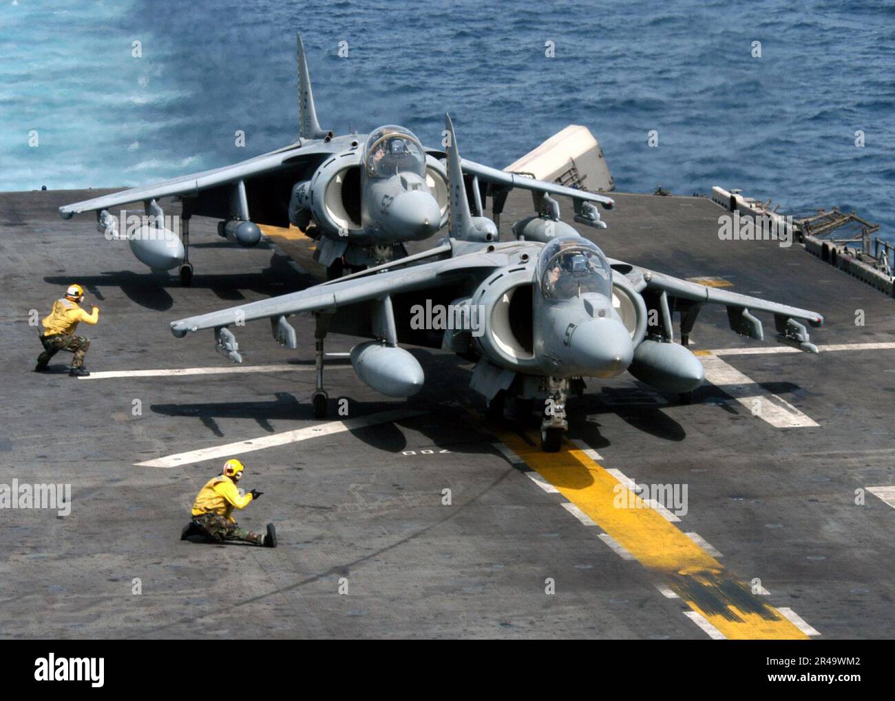 US Navy AV-8B Harriers get permission for take-off from the flight deck ...