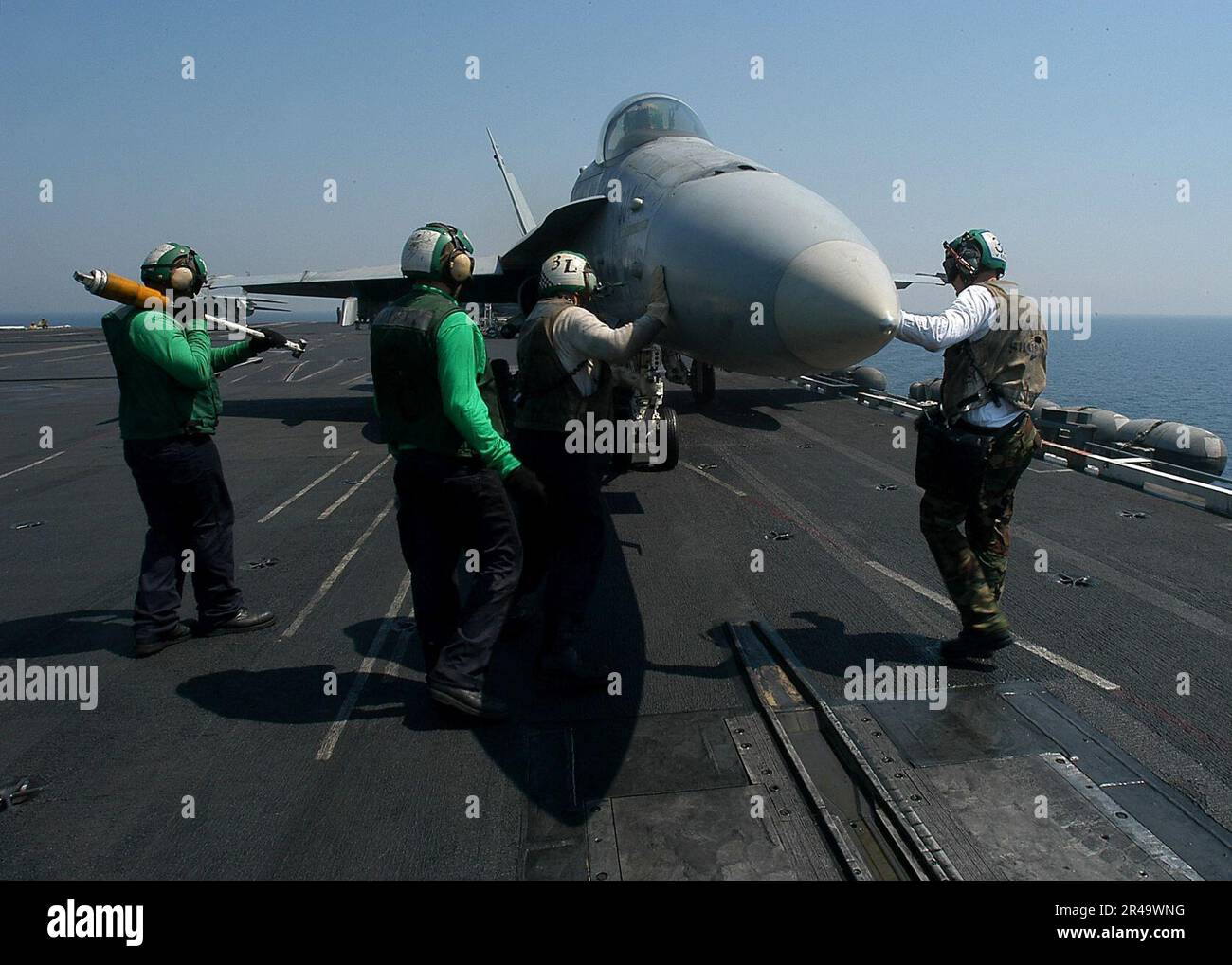 US Navy Squadron maintenance personnel perform a final inspection on an ...