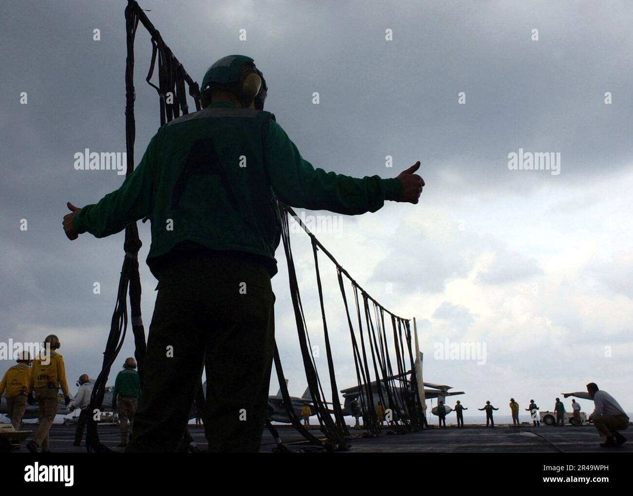 US Navy Flight deck personnel raise the ship's emergency aircraft ...