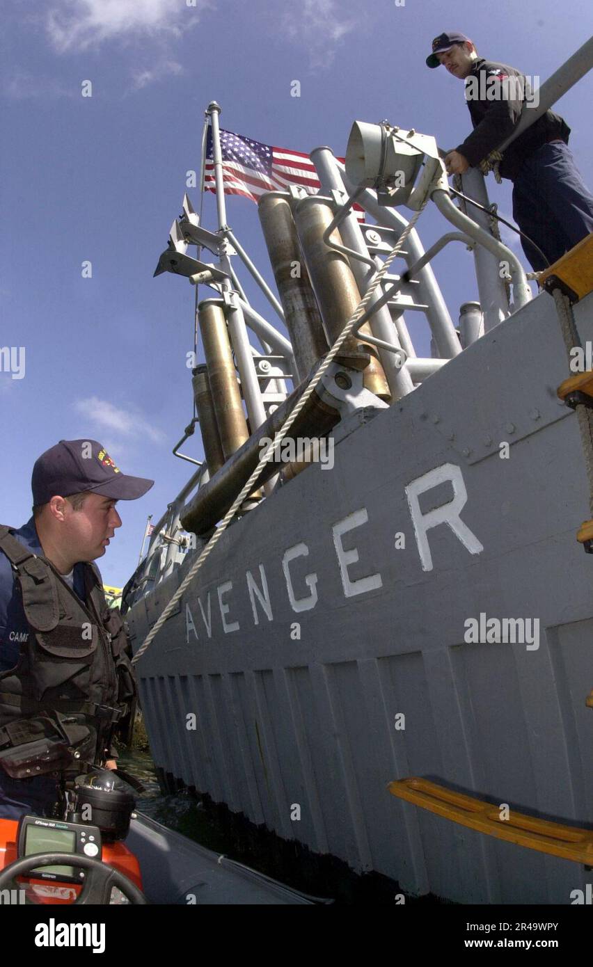 US Navy Mineman Seaman prepares to get a Rigid-Hull Inflatable Boat ...