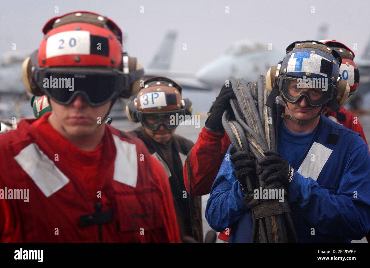 US Navy Airman right, stows emergency barricade rigging after ...