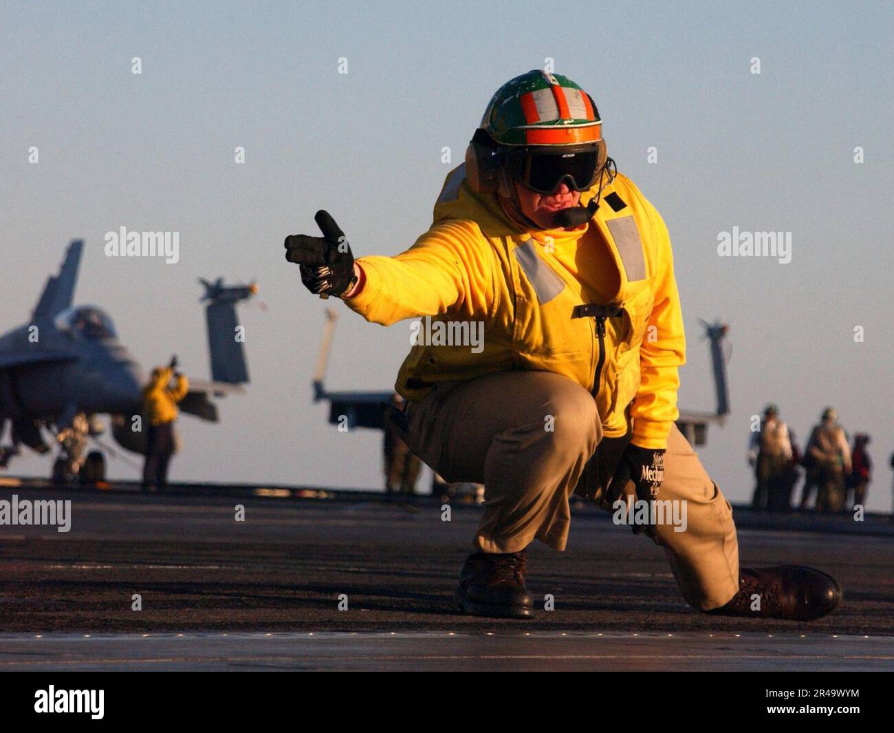 US Navy Lt. signals to launch one of four steam-powered catapults on ...