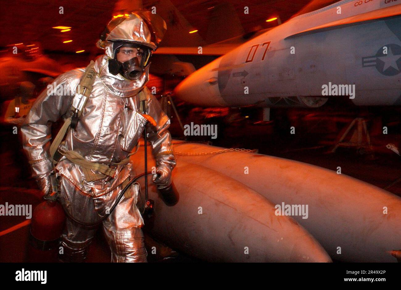 US Navy Aviation Boatswain's Mate grabs a CO2 fire extinguisher as he ...