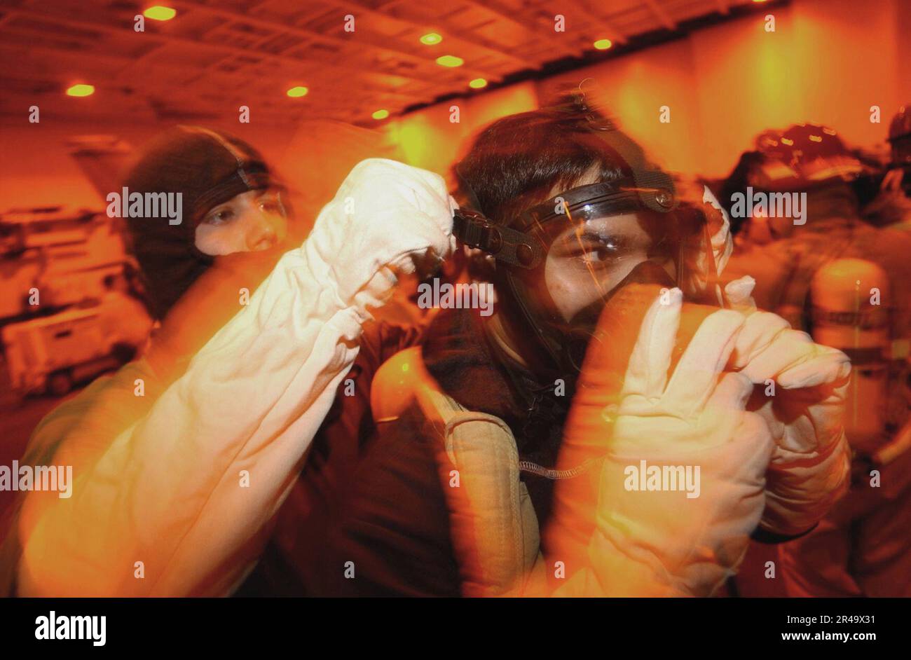US Navy Fire team members overlook one another ensuring that their Fire ...