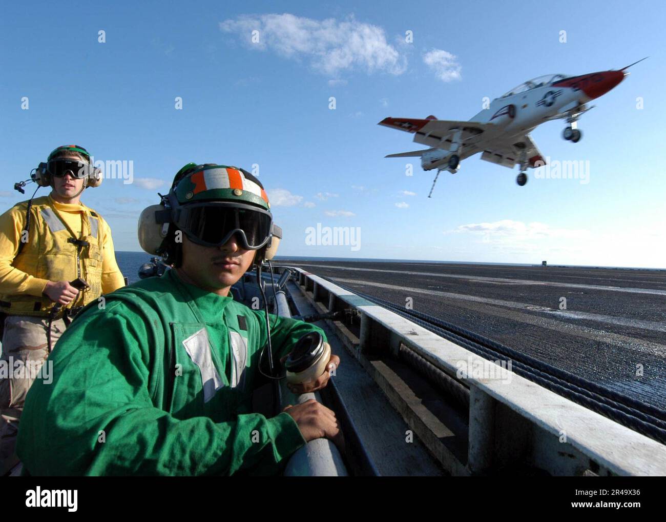 US Navy A deck edge operator and arresting gear officer ensure the ...