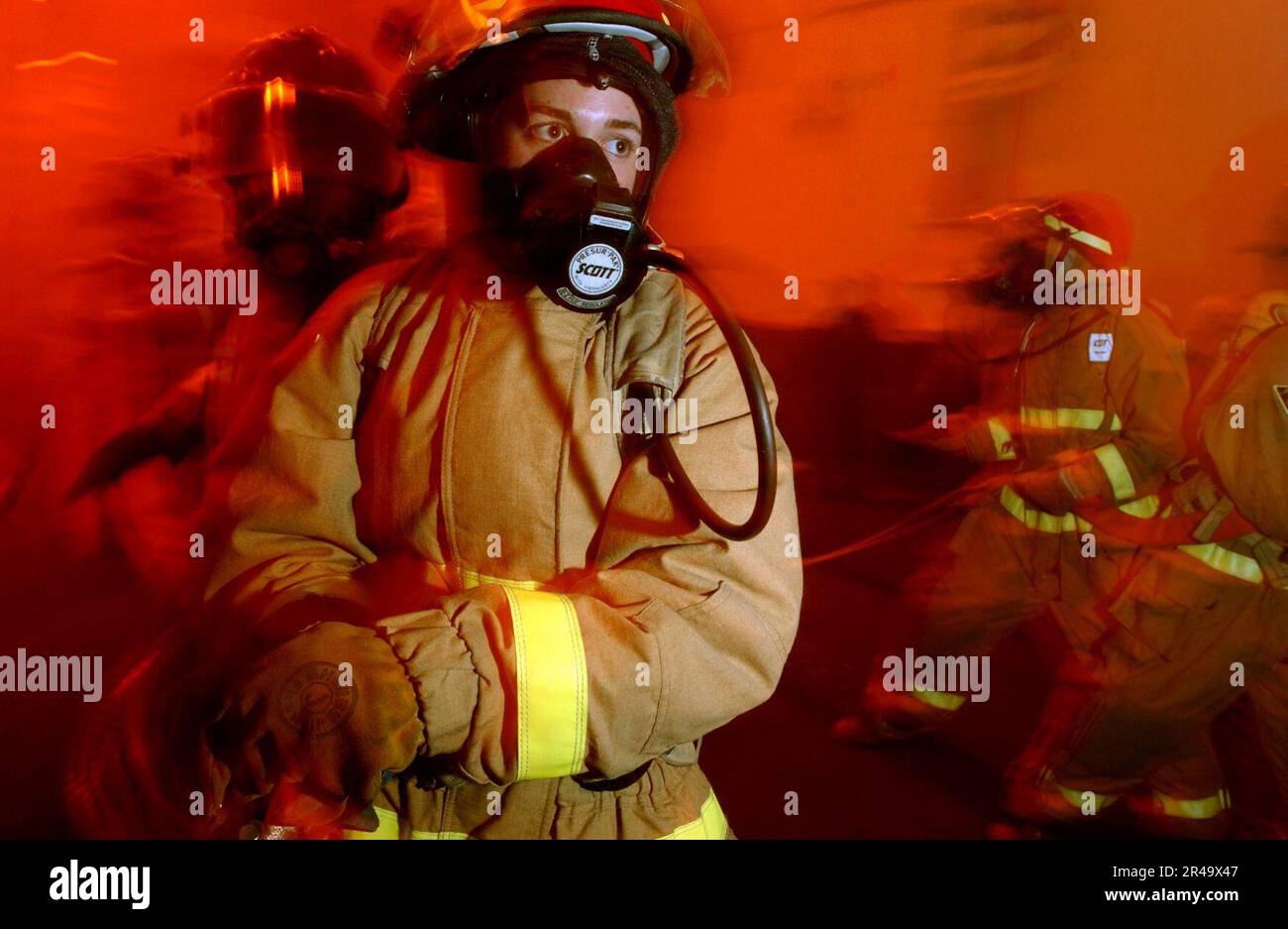 US Navy Journalist Seaman simulates fighting a fire in the hanger bay ...