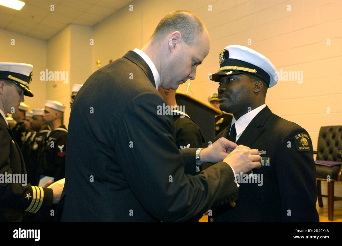 US Navy Assistant Navy Secretary Dionel Aviles pins the Navy and Marine ...