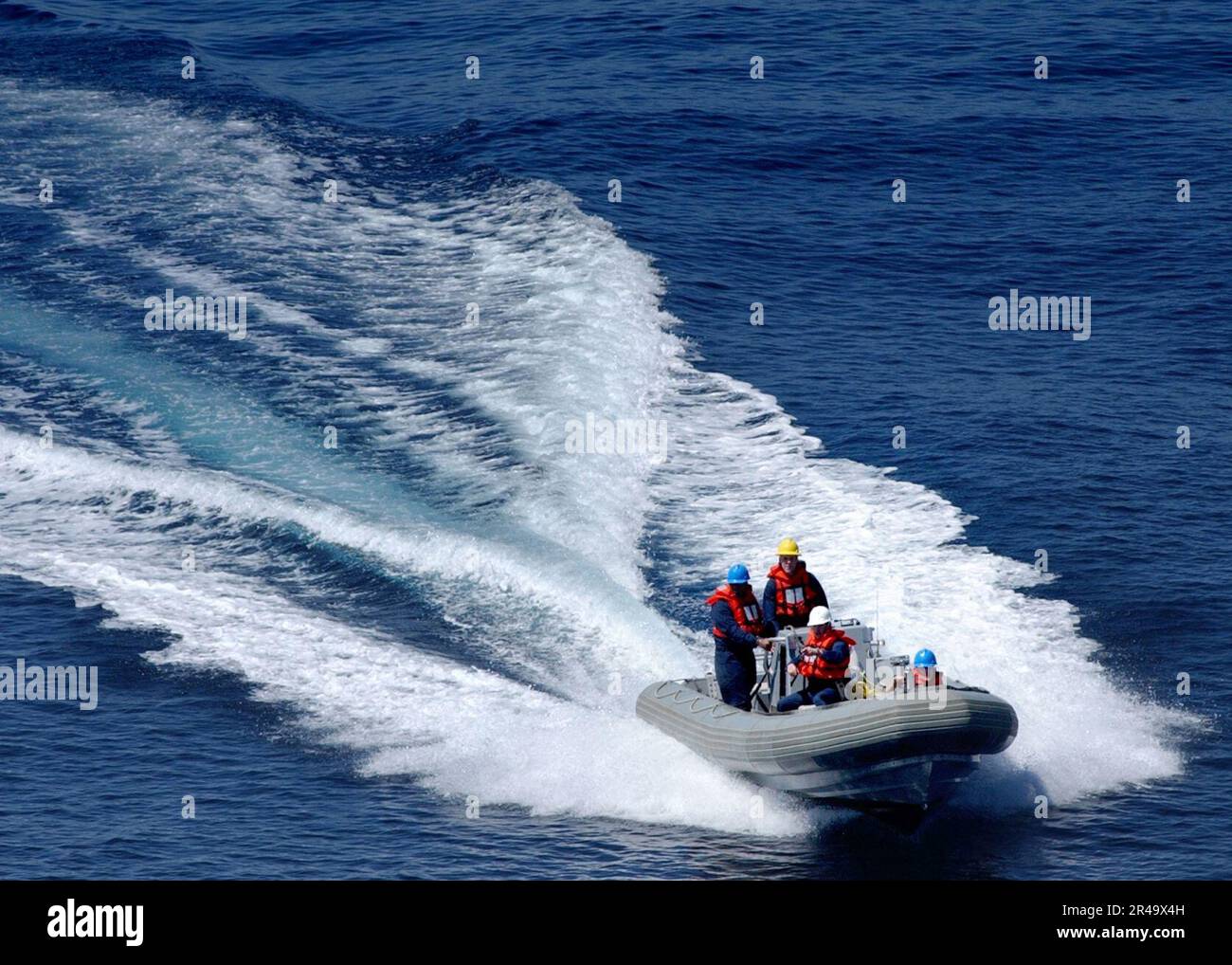 US Navy Sailors man a Rigid Hull Inflatable Boat (RHIB) during a ...