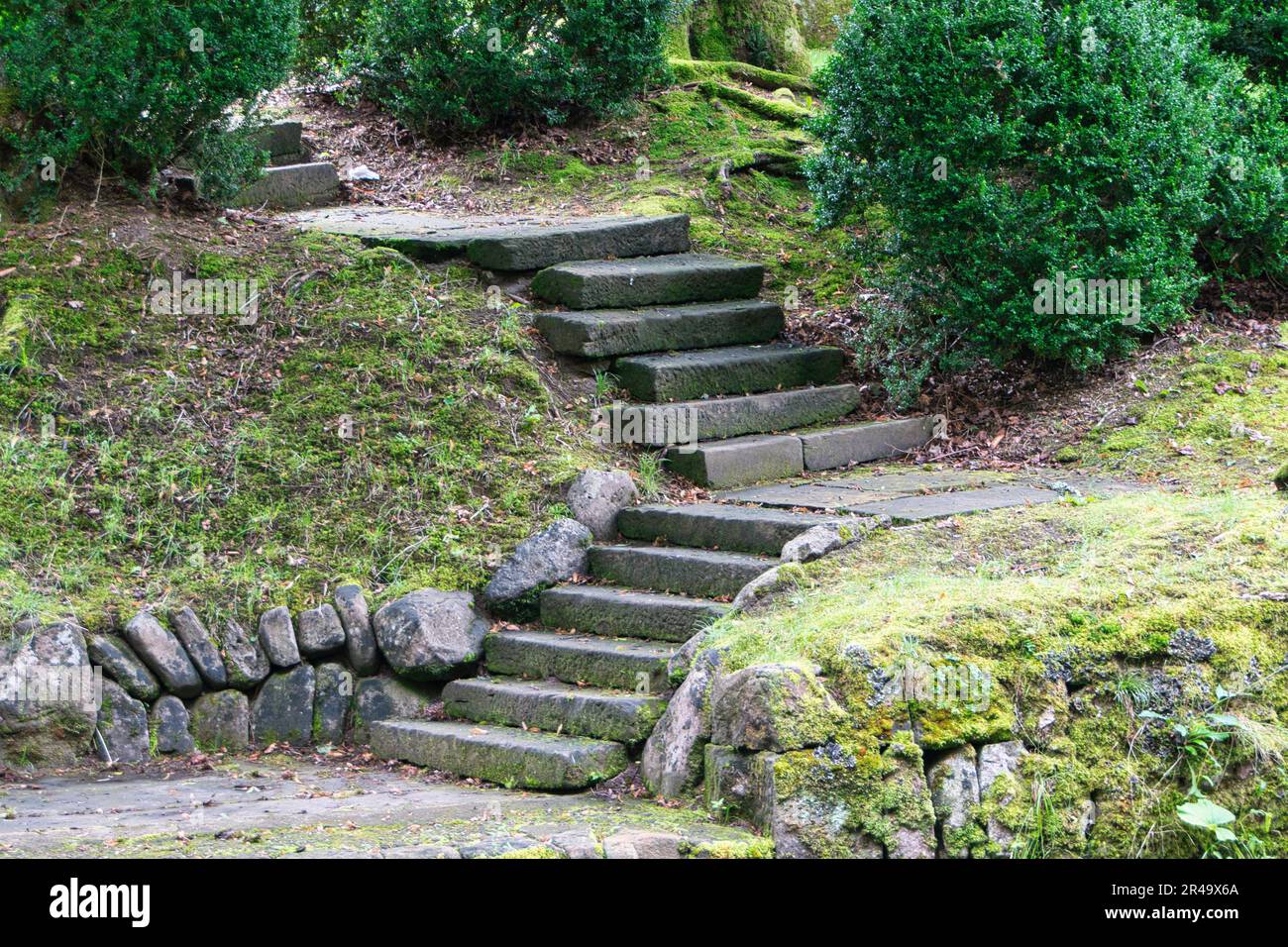A stone pathway leading up a hill featuring an obstacle along the path ...