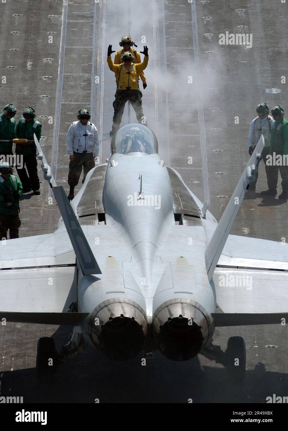 US Navy An Aviation Boatswain's Mate Handler directs an F-A-18 Hornet ...