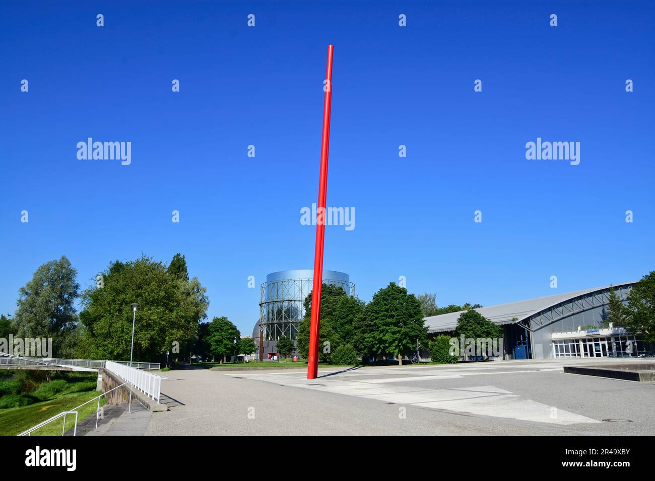 A vibrant red metal pole stands prominently against the backdrop of a ...
