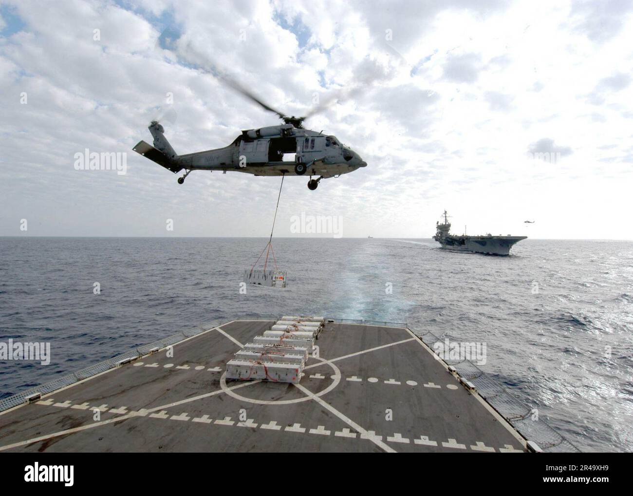 US Navy An MH-60S Knighthawk helicopter hovers above the flight deck of ...