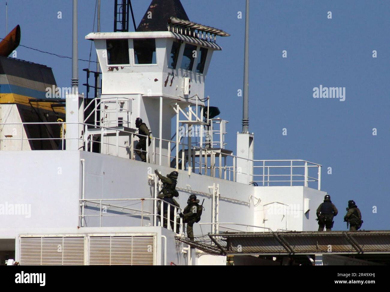 US Navy Italian Special Forces personnel make their way to the bridge of the Military Sealift ...
