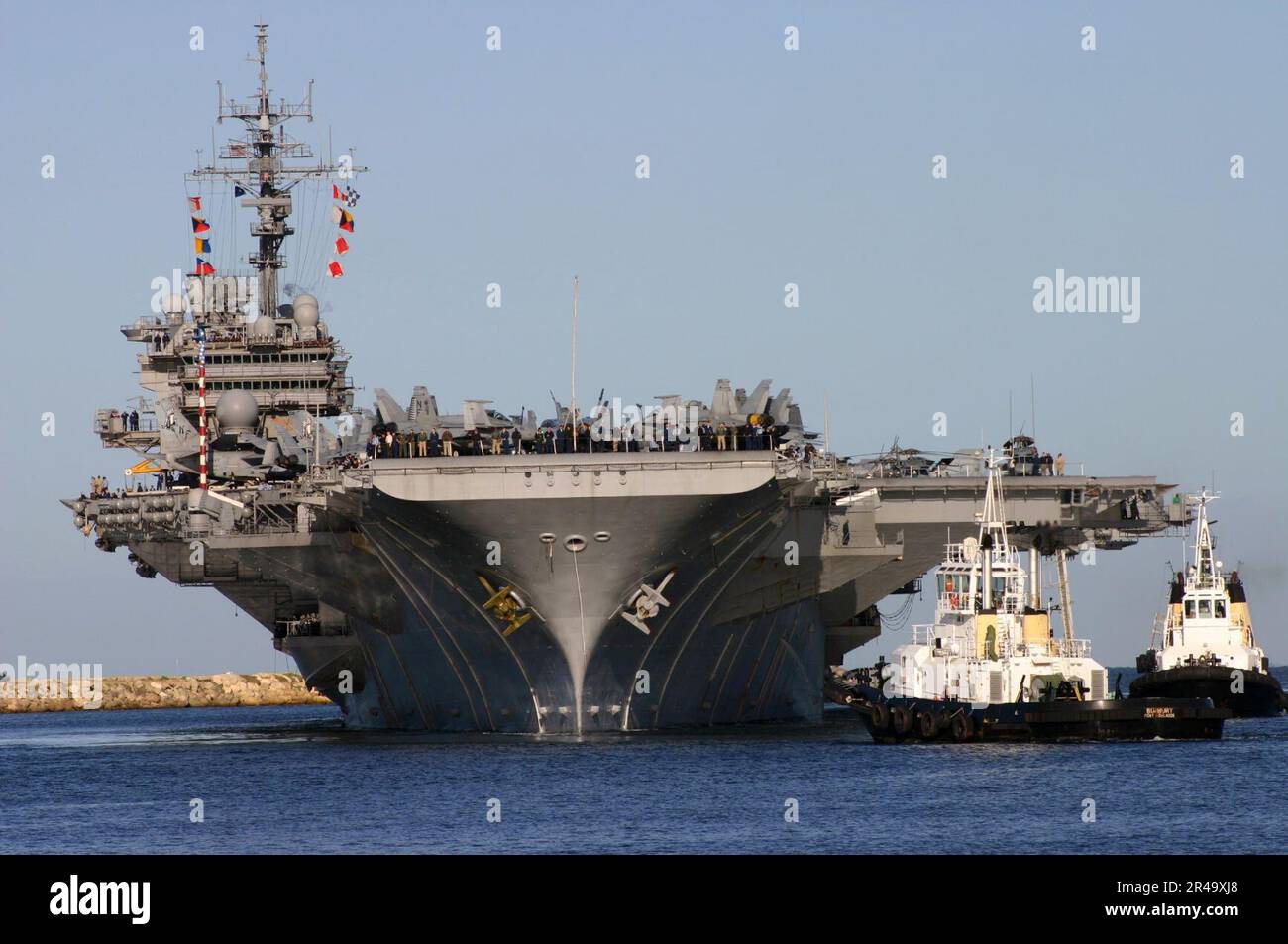 US Navy Tug boats escort USS Kitty Hawk (CV 63) and embarked Carrier ...