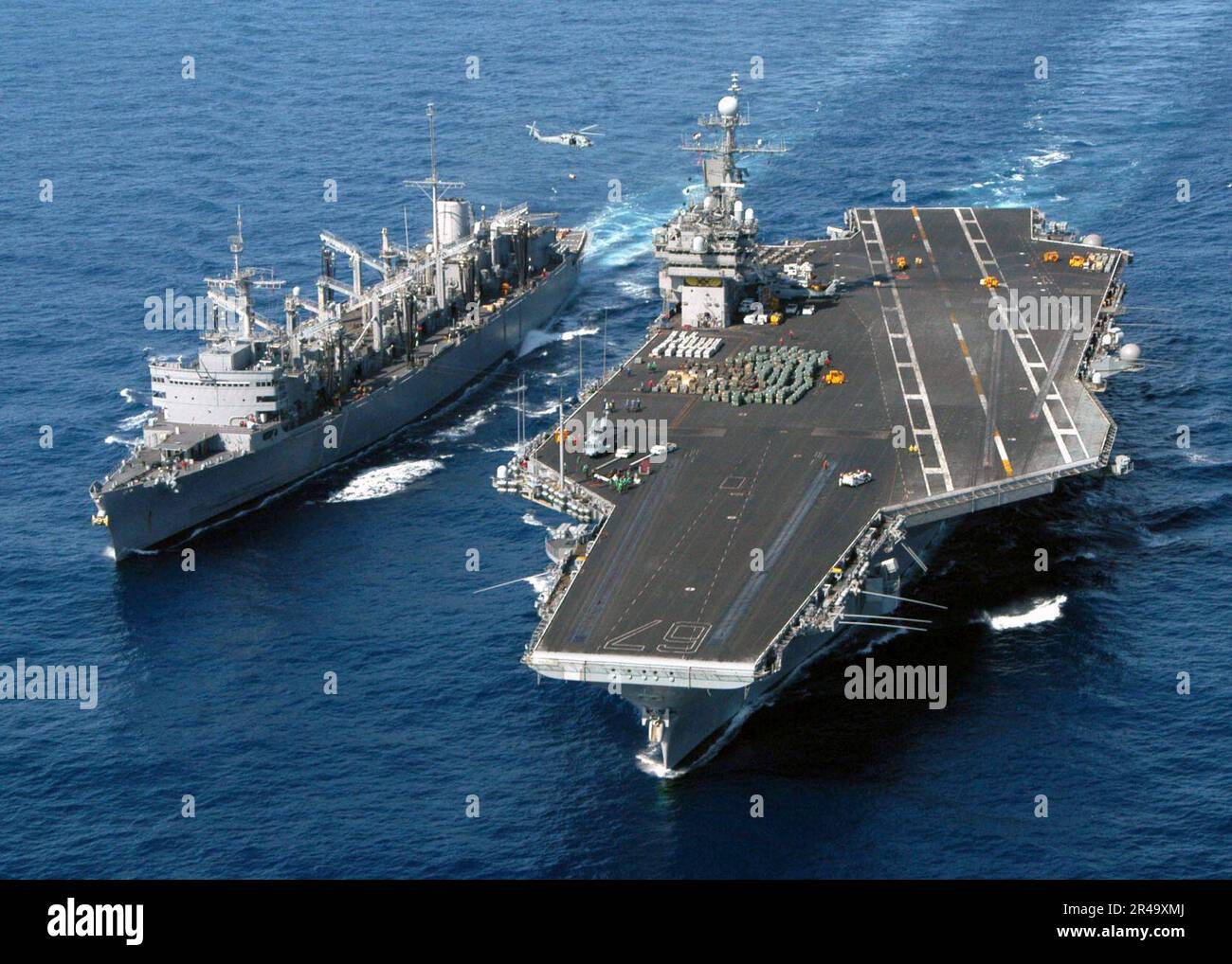 US Navy USS John F. Kennedy (CV 67) receives ordnance from the fast ...