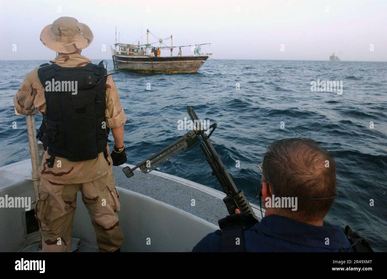 US Navy Gunner's Mate 1st Class stands by with a M-60 machine gun to ...