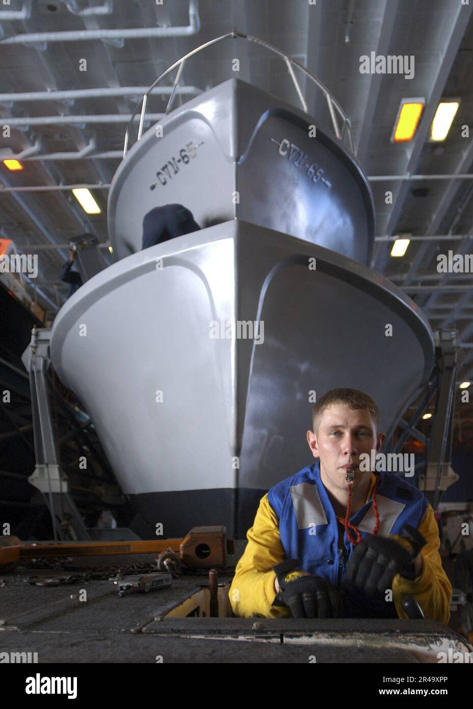 US Navy Airman hauls a motor whaleboat and the Captain's Gig, in the ...