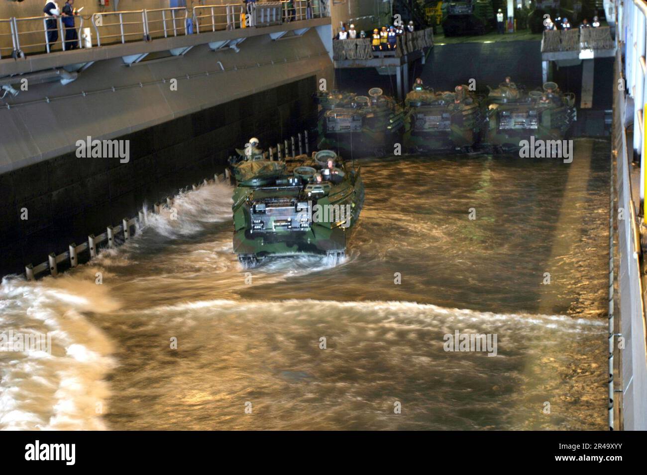 US Navy An Amphibious Assault Vehicle maneuvers inside the well deck ...
