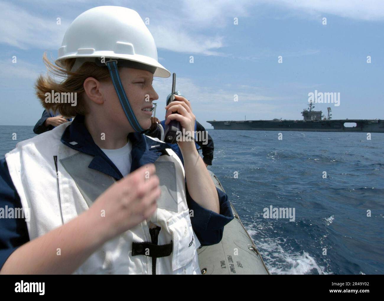 US Navy A Rigid Hull Inflatable Boat (RHIB) team leader communicates ...