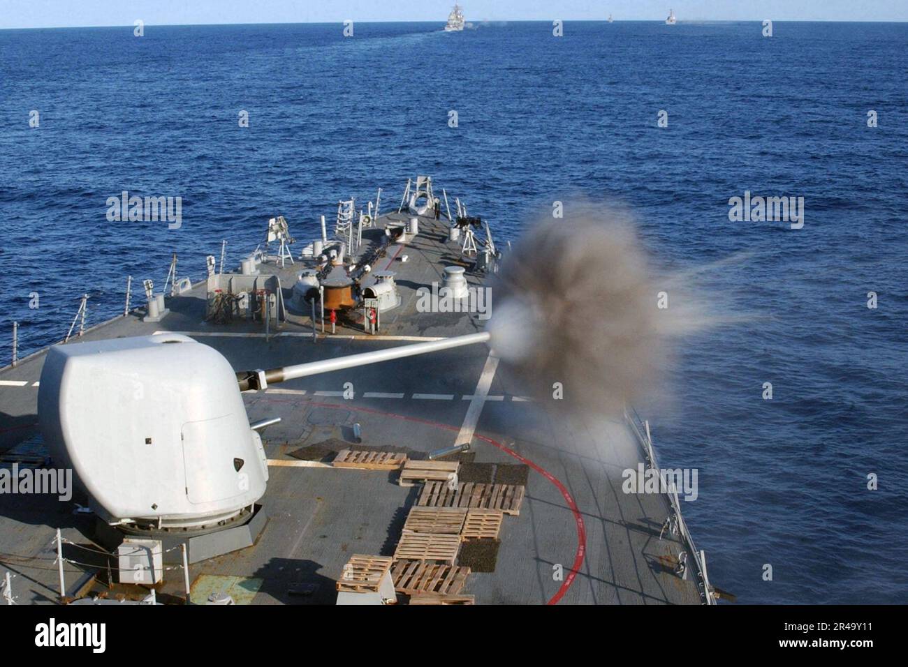 US Navy USS Barry (DDG 52) fires her forward mounted Mk-45-5 54 cal ...