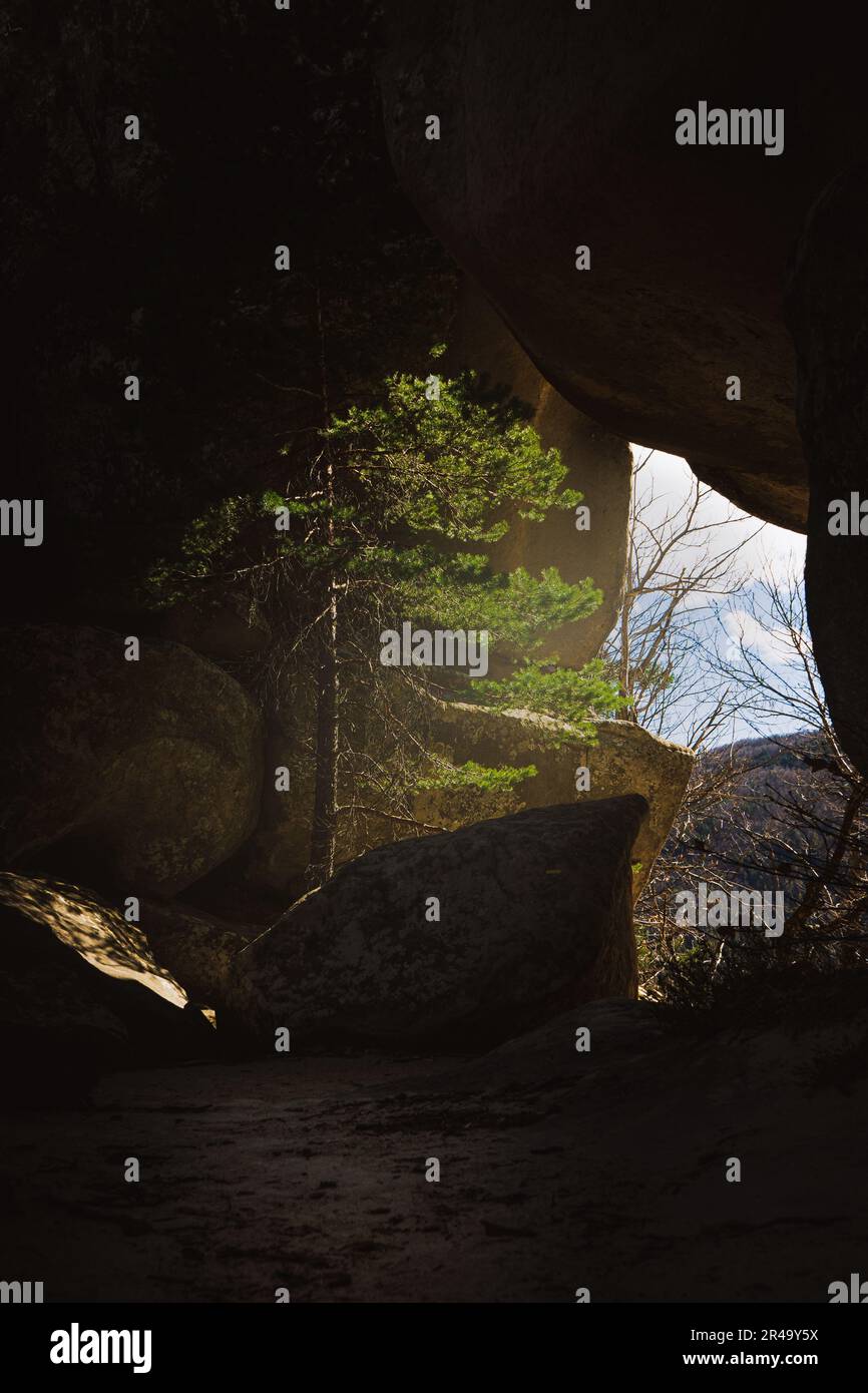 The natural light streaming through a cave entrance, illuminated by the ...