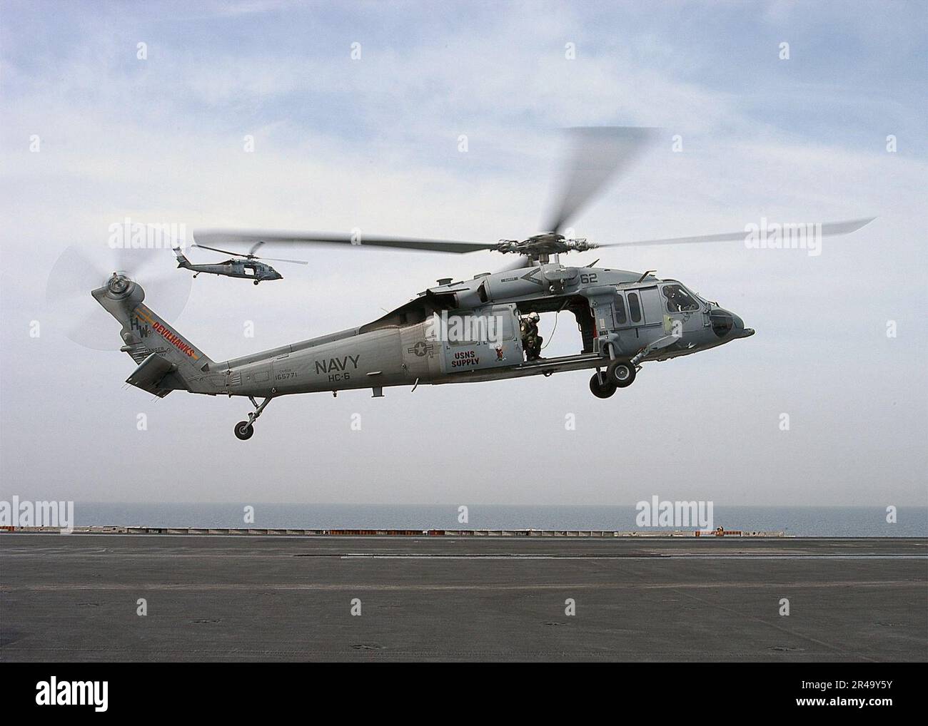 US Navy An MH-60S Nighthawk prepares to land on the flight deck aboard ...