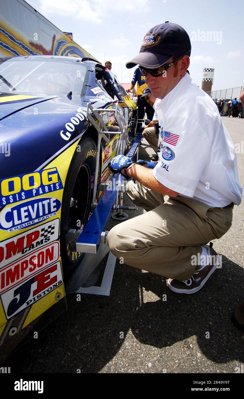 US Navy A NASCAR race official measures the wheel specifications on the ...