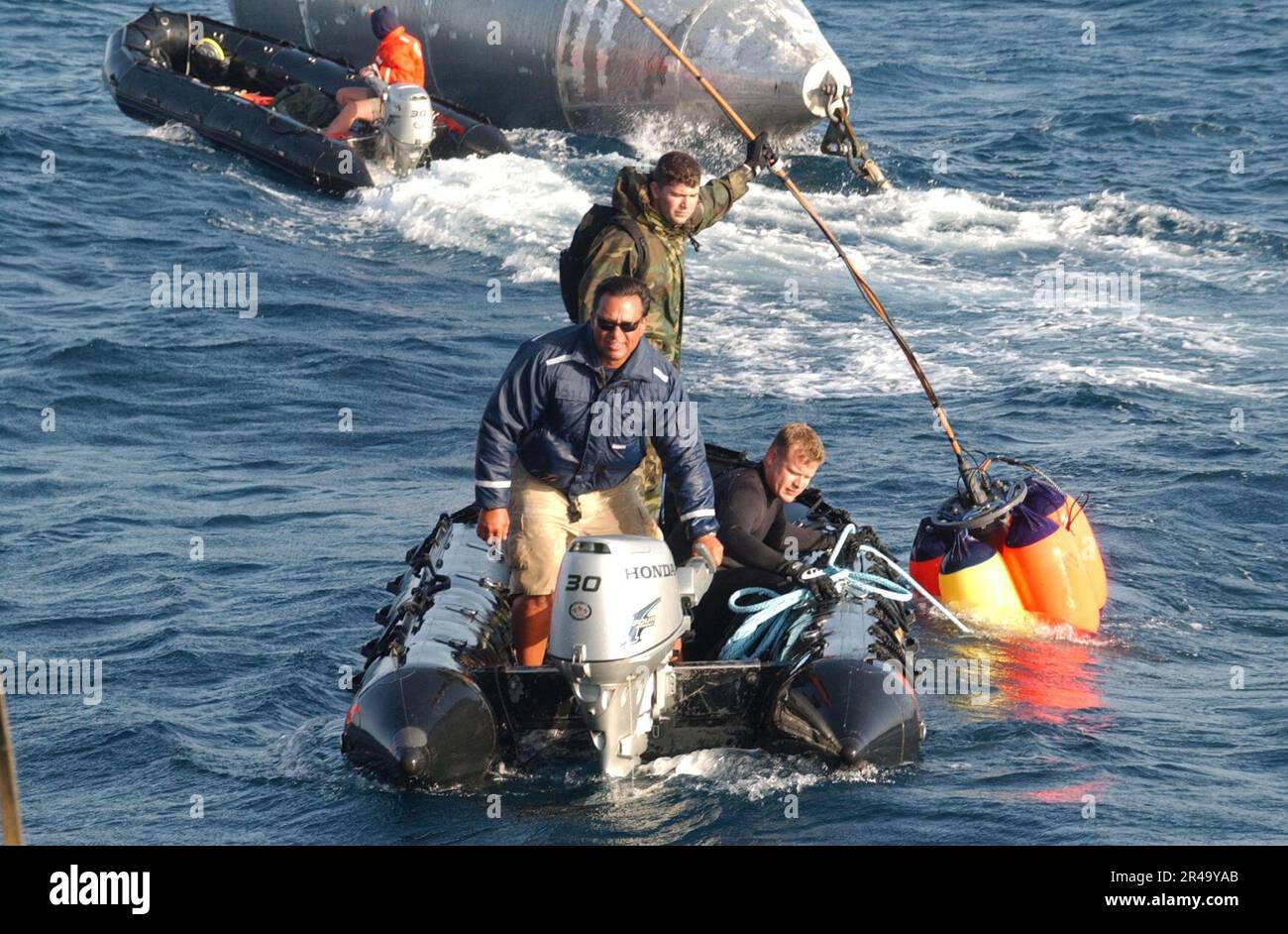 US Navy Navy divers position an underwater listening device next to a ...