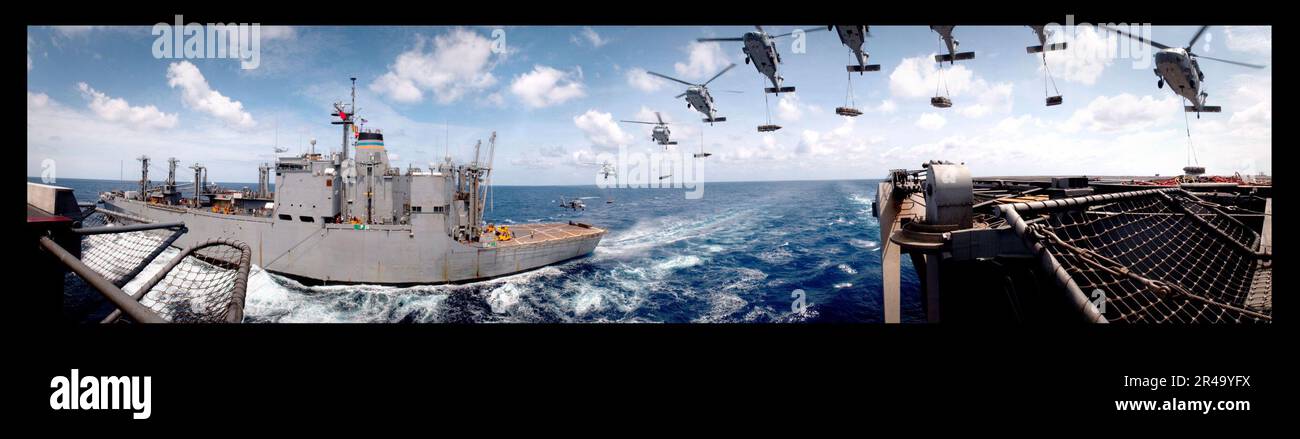 US Navy An MH-60S Knighthawk helicopter carries a load of bombs while ...
