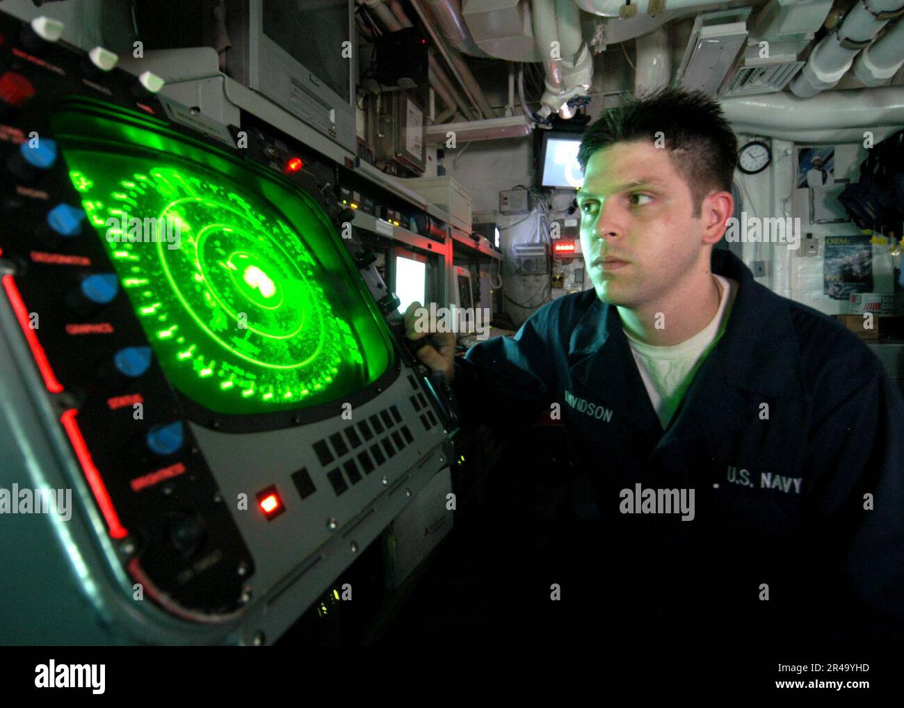 US Navy Aerographer's Mate Airman reviews the AN-SPA radar screen that ...
