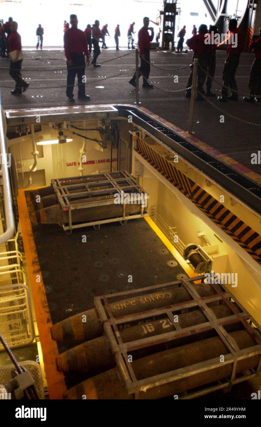 US Navy Ordnance is transported via weapons elevator from the flight ...