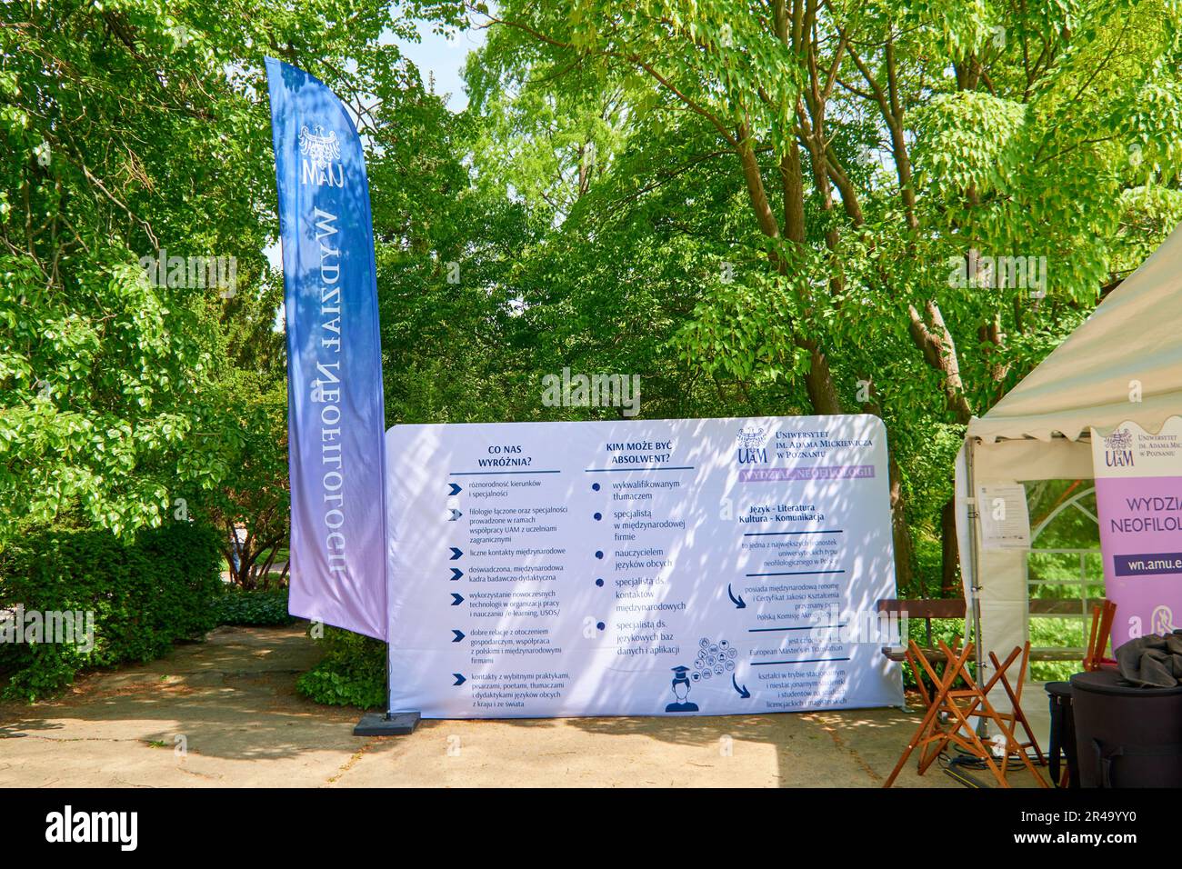 An outdoor camping setup comprising of a tent, two flags and two chairs ...