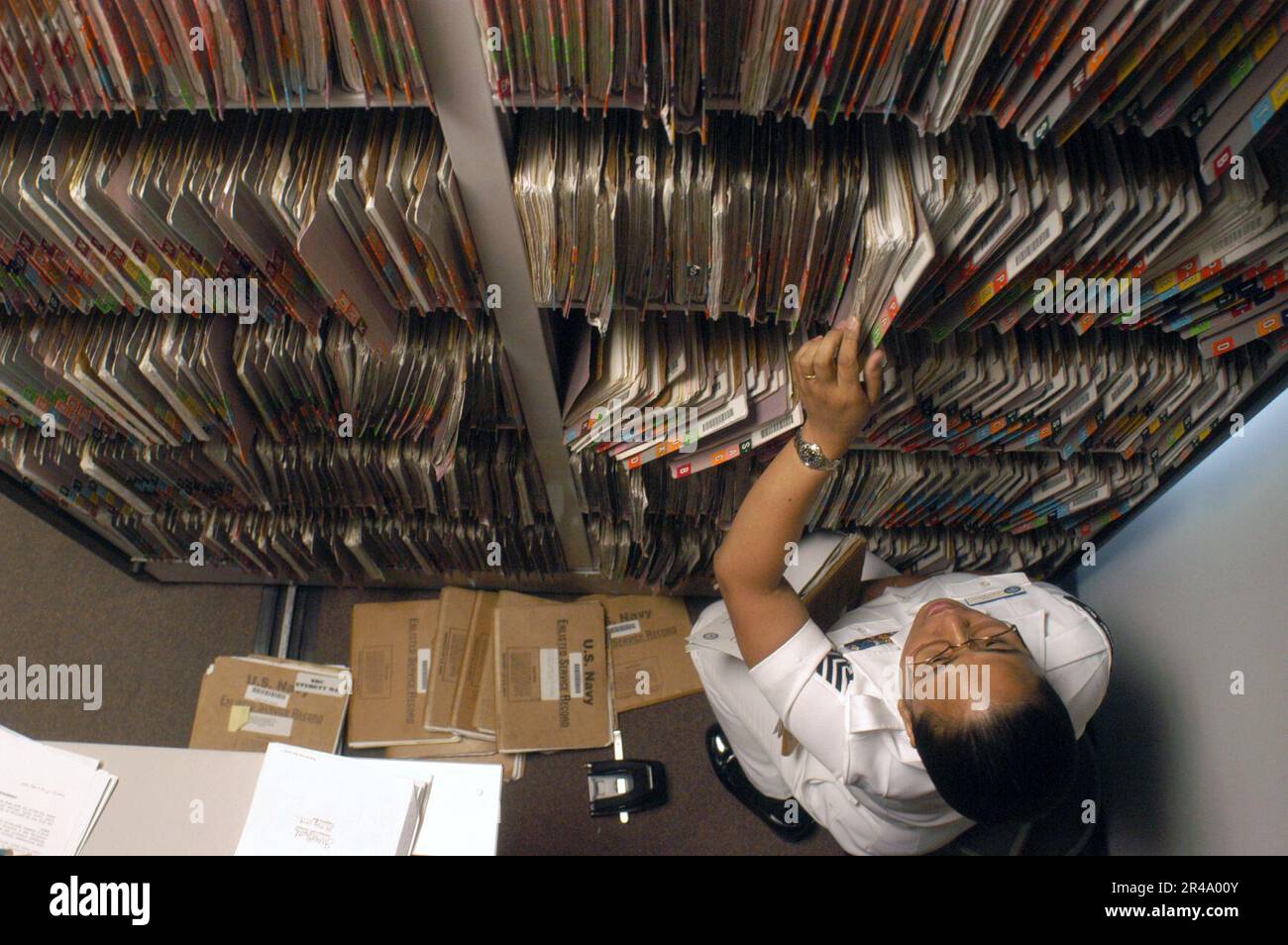 US Navy Personnelman 1st Class maintains service records at the ...