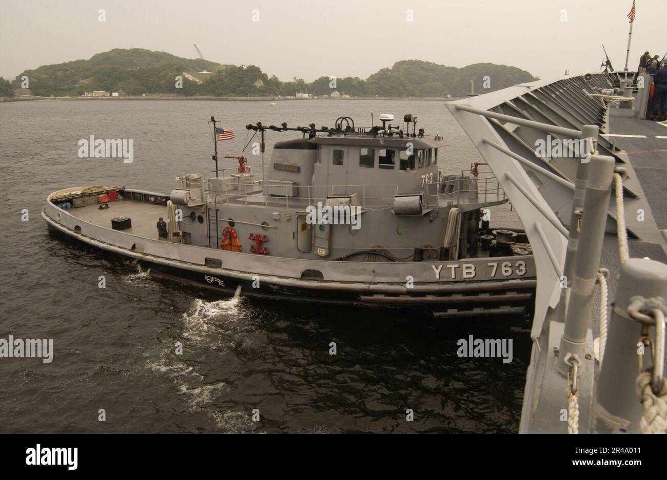US Navy Harbor tug USS Muskegon (YTB 763) assists the guided missile ...