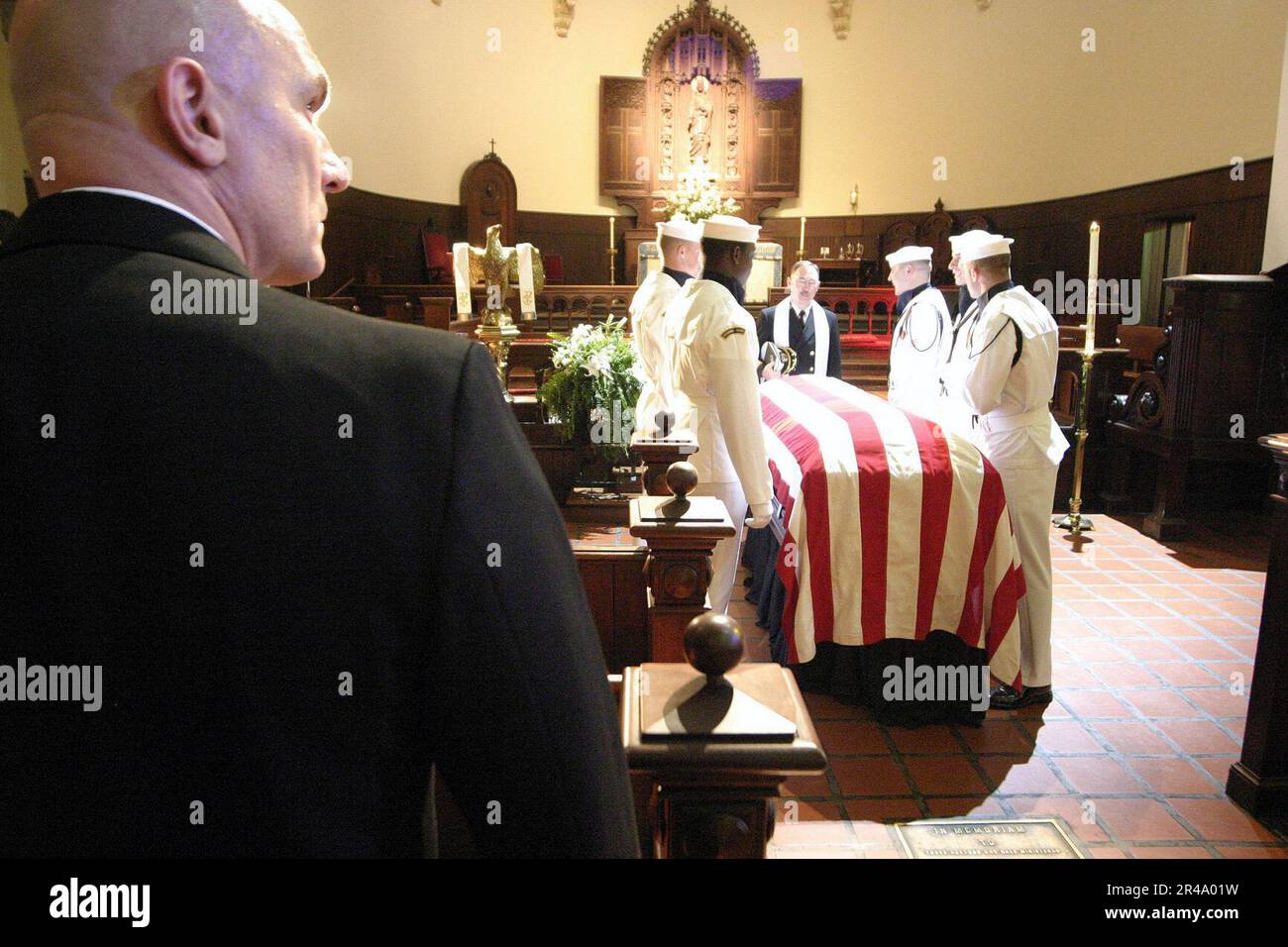 US Navy Lt. Cmdr. left, observes the set-up of a scene being filmed for ...