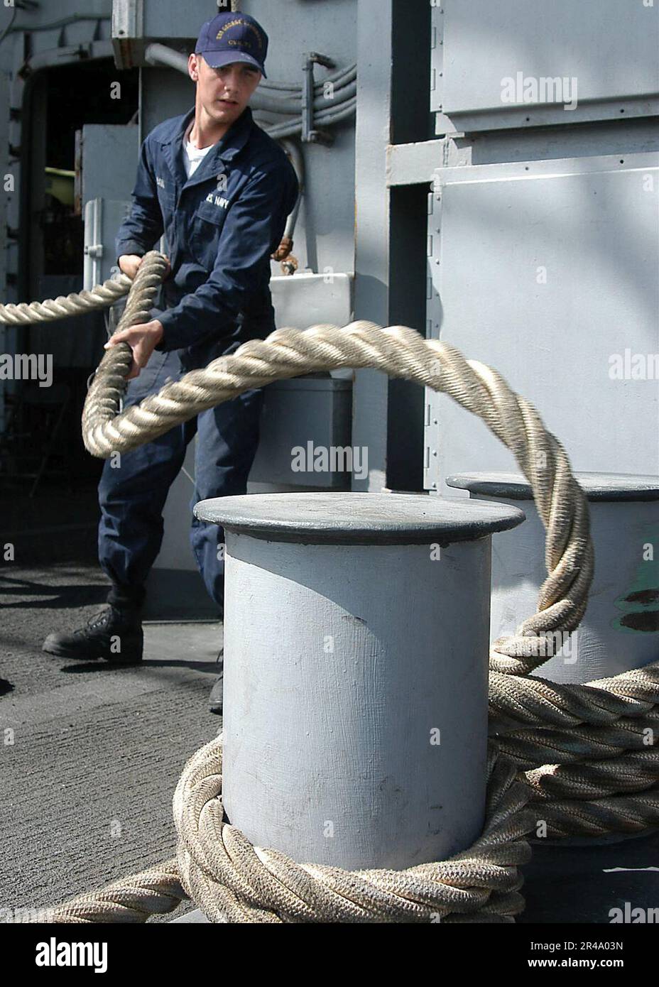 US Navy Seaman unwraps the line around the bits on the fantail Stock ...