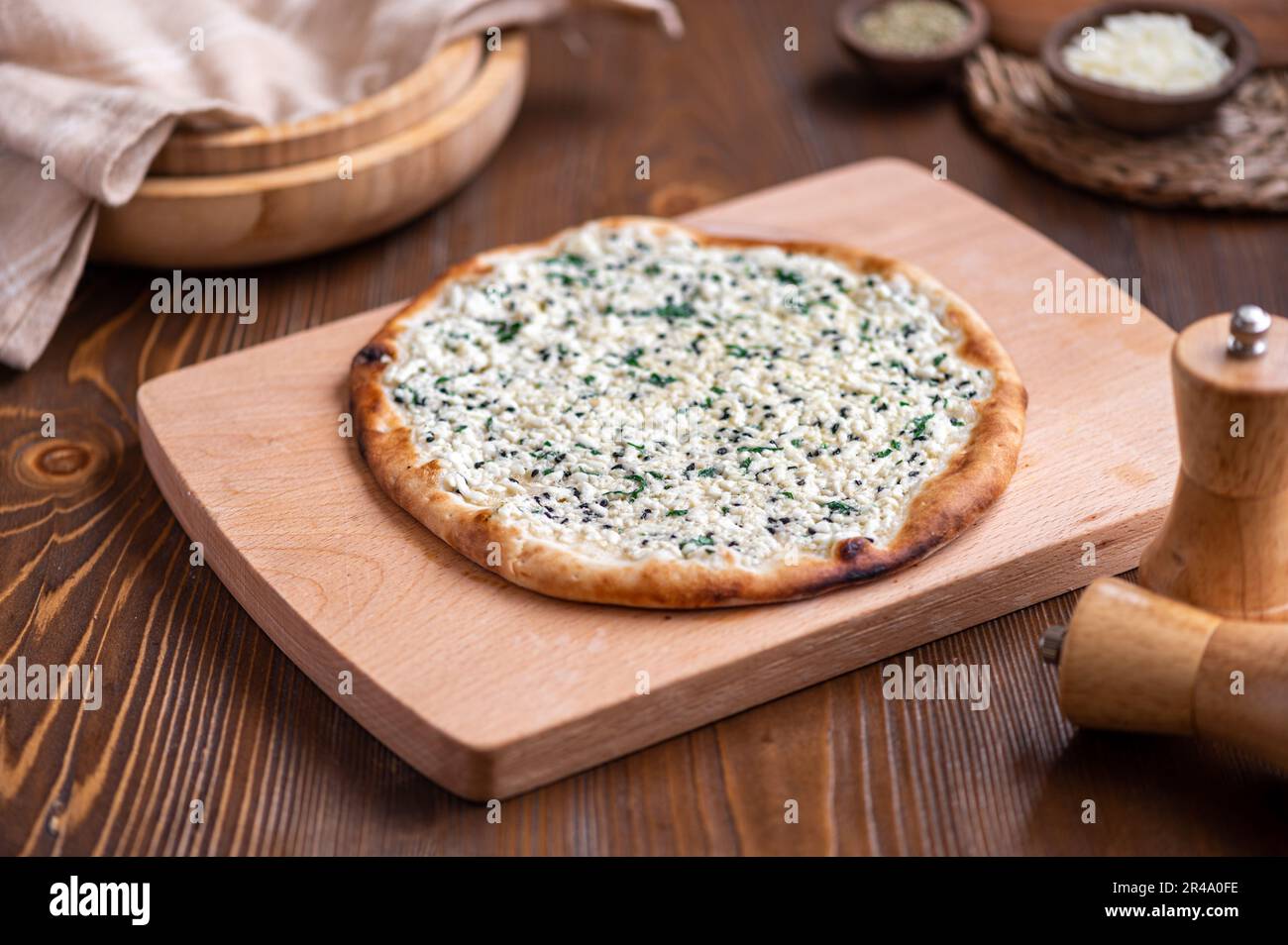 A traditional Middle Eastern spiced flatbread manaqish, topped with ...