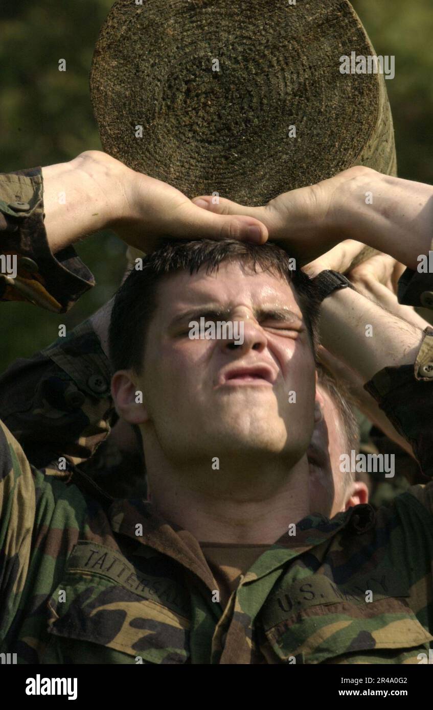 US Navy A Midshipman grimaces as he and his squad lift a log above ...